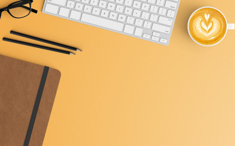 Directly Above Shot Of Coffee Cup By Keyboard On Table - Global Custodian
